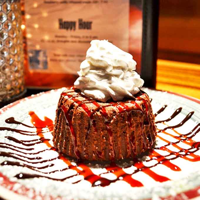 A chocolate lover's dream finale &ndash; warm cake, cool cream, and that magical moment when the first spoonful reveals the molten center.