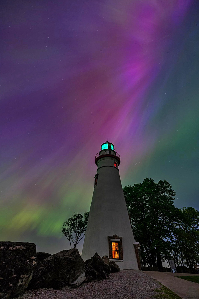 The Northern Lights dance above the lighthouse in a rare celestial display – nature's own light show complementing this historic beacon in a truly magical moment.