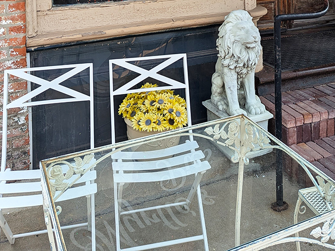The outdoor seating area, guarded by a stone lion, offers a pleasant spot to savor your slice in the fresh Illinois air.