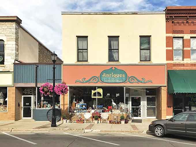 The welcoming exterior of Antiques of Northfield stands as a colorful invitation on Division Street, promising treasures within its historic walls.