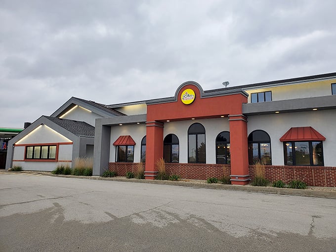 The distinctive exterior architecture of R-Place stands out among highway exit offerings, promising something far beyond typical road food inside.