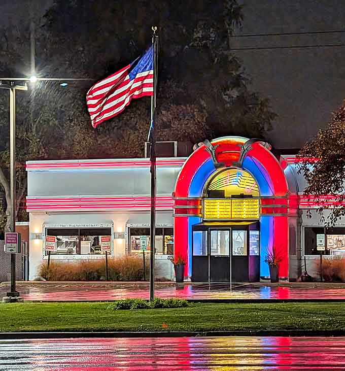 Evening lights transform the jukebox exterior into a glowing beacon, calling hungry travelers to their delicious rock and roll destiny.