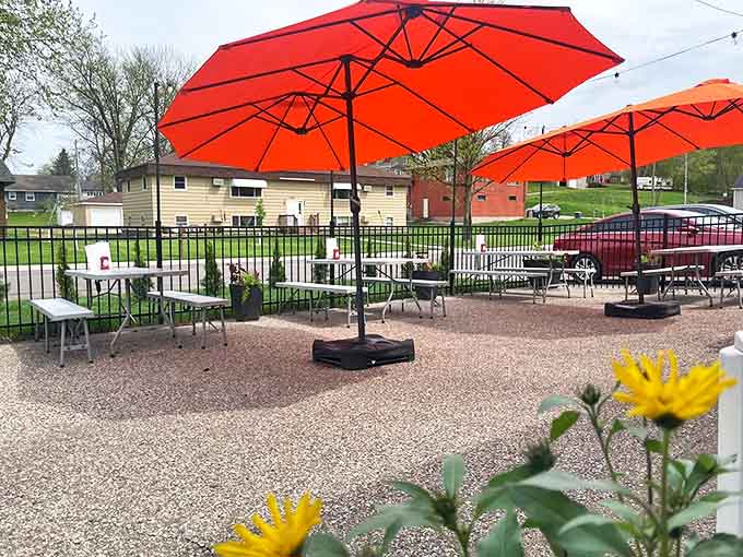 The outdoor patio with bright orange umbrellas offers a sunny retreat for enjoying smoky delights al fresco during Minnesota's precious warm months.