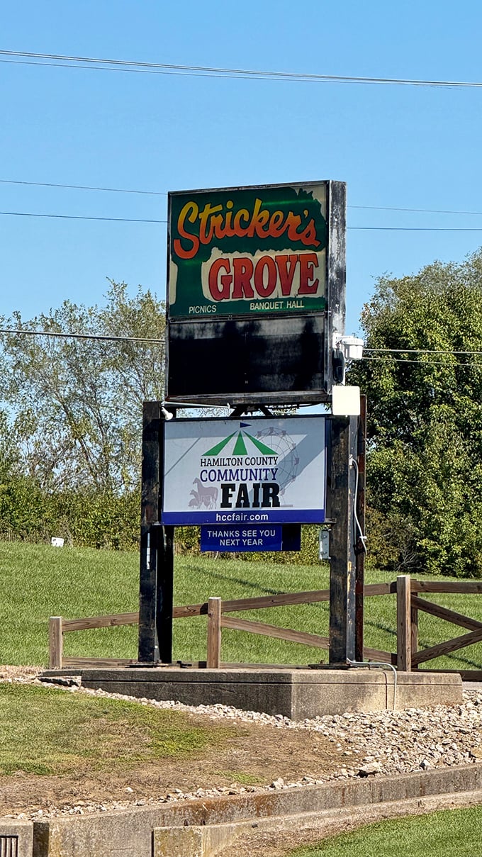 The vintage Stricker's Grove sign stands as a roadside beacon, promising visitors an escape to simpler times and uncomplicated joy.