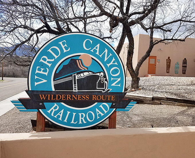 The railroad's distinctive logo serves as both landmark and promise &ndash; wilderness adventures await just beyond this sign, no hiking boots required.
