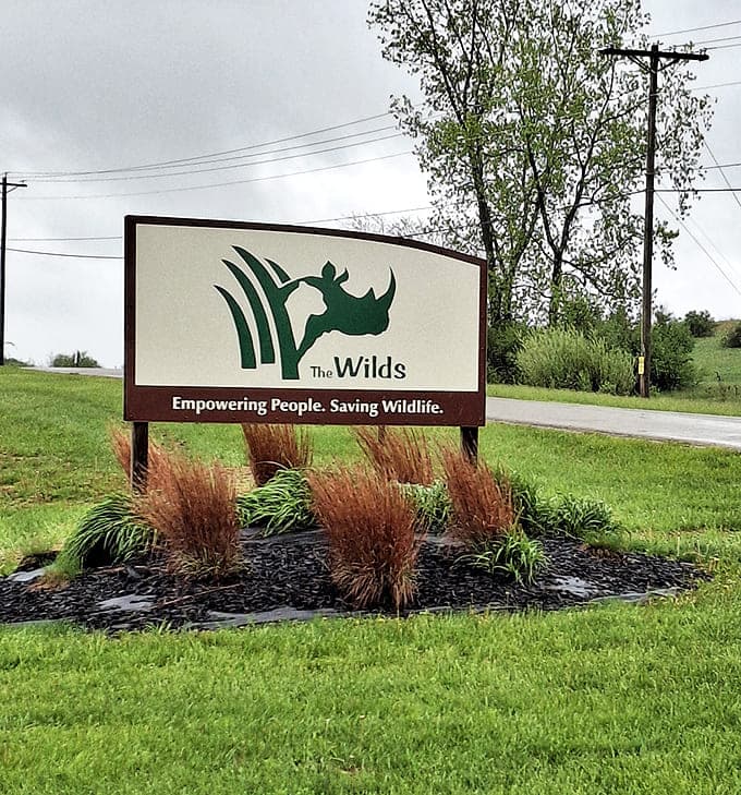 The Wilds' entrance sign promises exactly what it delivers: a mission of empowerment and wildlife preservation in the heart of Ohio.