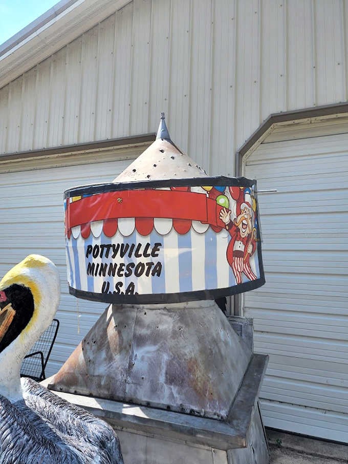 "Pottyville, Minnesota, USA" proclaims this carnival-style sign, turning bathroom humor into an official tourist destination worth celebrating.