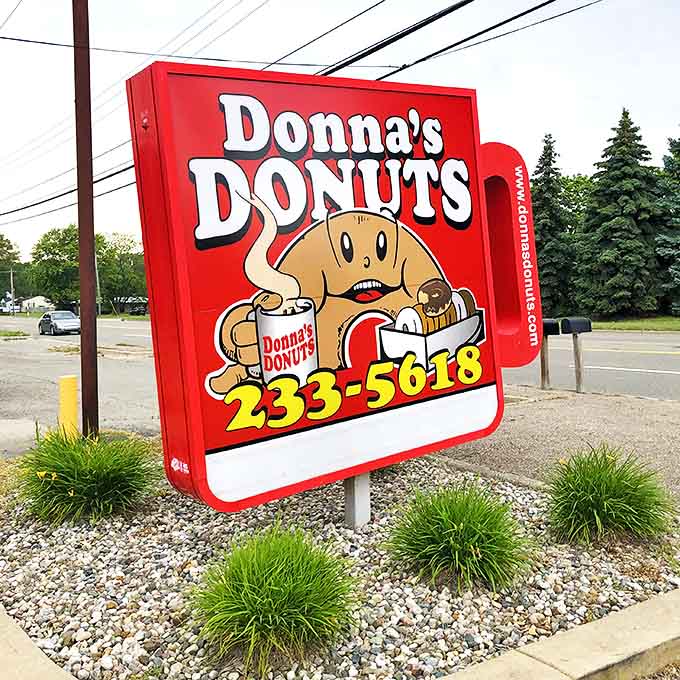 The iconic Donna's sign stands as a beacon of hope for donut lovers, promising handcrafted perfection just steps away.