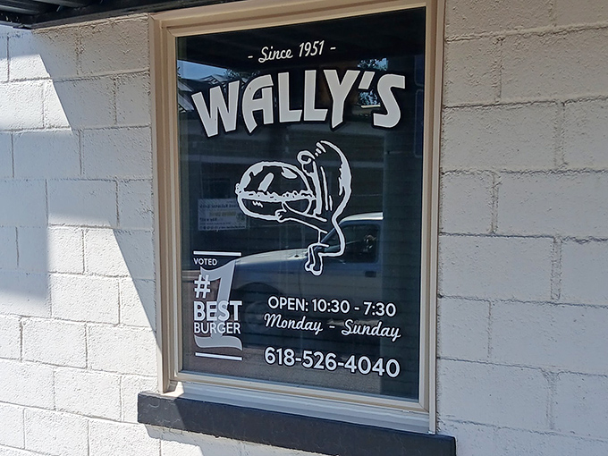 Wally&rsquo;s window proudly announces its hours and longtime reputation as a favorite local burger stop.