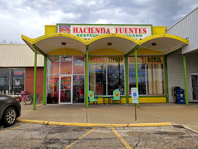 The distinctive curved awning and bright yellow exterior make Hacienda Fuentes an unmistakable landmark – a beacon of authentic flavors in the neighborhood.