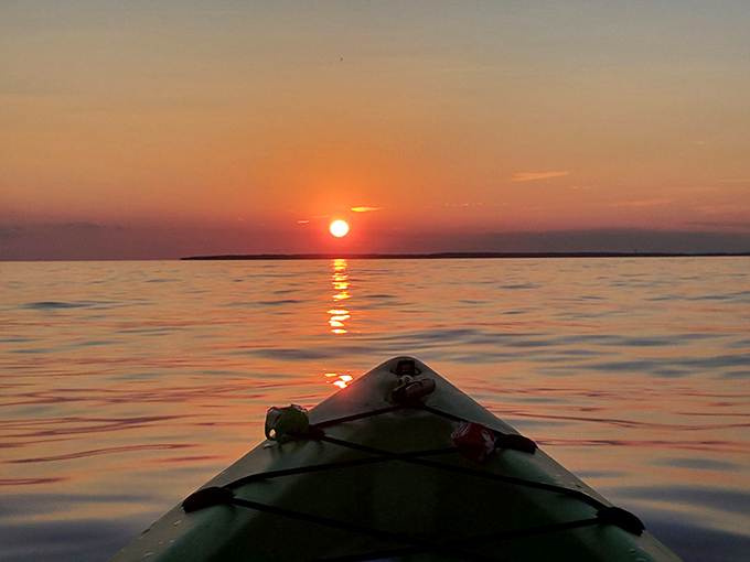 A Lake Erie sunset transforms an ordinary kayak into the best seat in nature's theater, the perfect end to an island day.