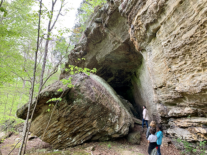 Visitors marvel at massive rock formations, providing scale that reminds us how small we are in nature's grand geological timeline.