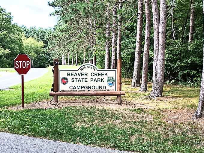 The Beaver Creek State Park campground entrance sign stands sentinel among tall pines, promising nights under stars and mornings with birdsong alarm clocks.