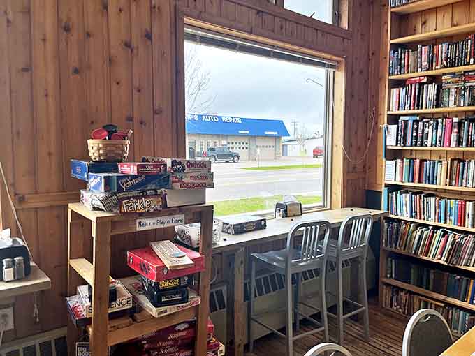 Window seat: Board games and books await by sunlit windows – the perfect perch for watching Munising life unfold between turns.