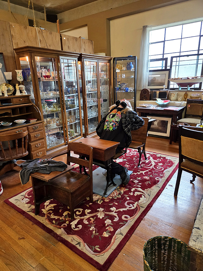 This cozy vignette invites you to imagine working at the antique desk or relaxing in the vintage chair, surrounded by treasures from another era.