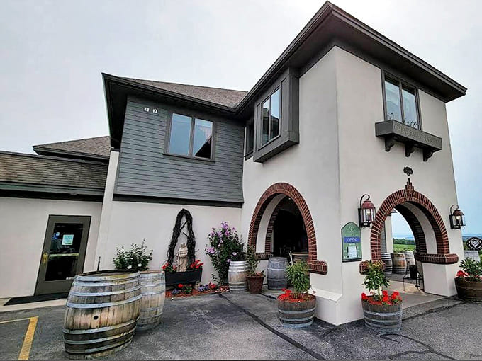 Entrance: Welcoming arched doorways flanked by wine barrels and colorful flowers set the stage for the memorable experience waiting just beyond the threshold.
