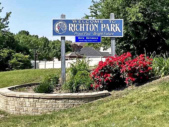 "Proud Past – Bright Future" declares the welcome sign, framed by carefully tended flowers that speak volumes about community pride.