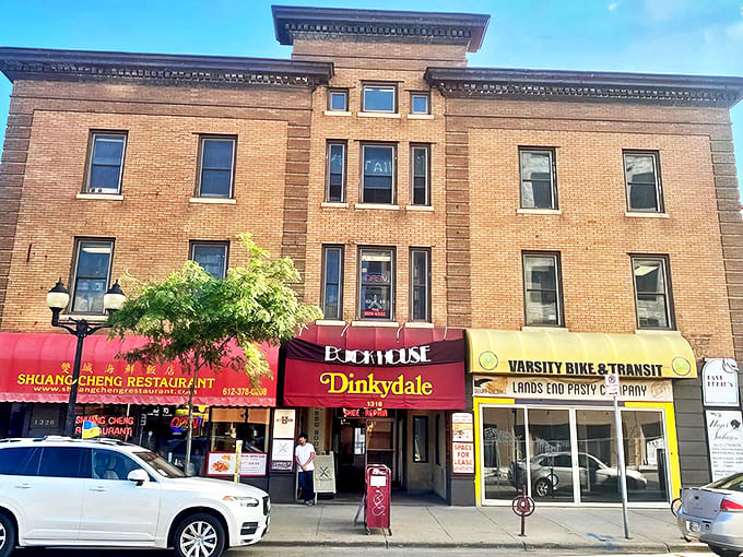 Edelweiss Bakery's charming brick exterior welcomes visitors with white-trimmed windows and a playful cow statue &ndash; Minnesota's little slice of Alpine charm.