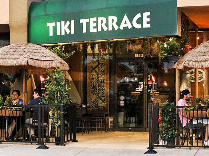The vibrant green awning of Tiki Terrace beckons like a tropical mirage in the Illinois landscape, promising island escape just steps away.