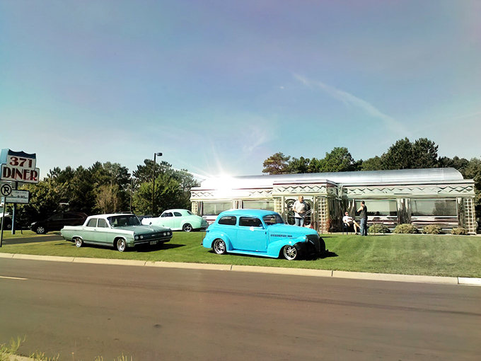 The gleaming chrome exterior of 371 Diner in Baxter shines like a time machine to the 1950s, complete with vintage cars parked outside.