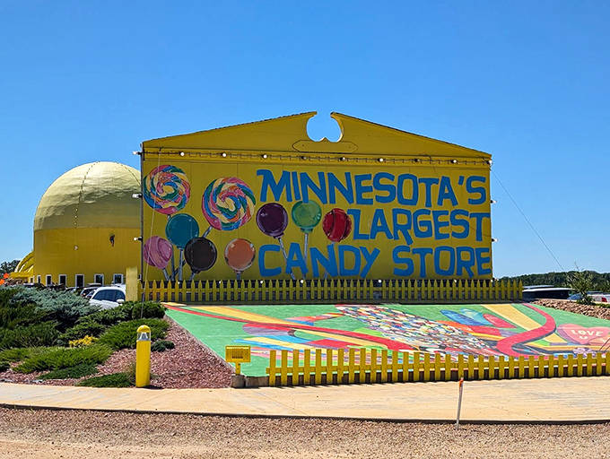 The sunshine-yellow exterior of Minnesota's Largest Candy Store stands out like a beacon of sweetness against the blue sky, promising a colorful adventure inside.