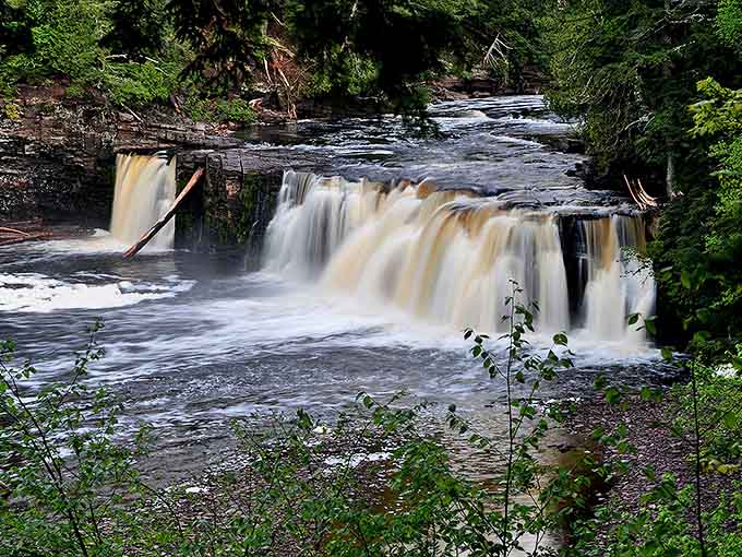 Presque Isle's golden waters cascade over ancient stone steps, creating nature's own stairway to heaven.