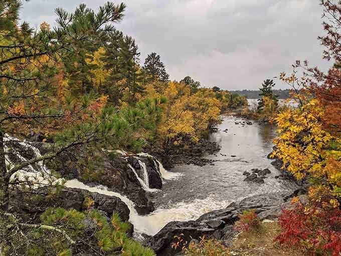 Fall colors frame the rushing water perfectly, creating a scene that belongs on a postcard.