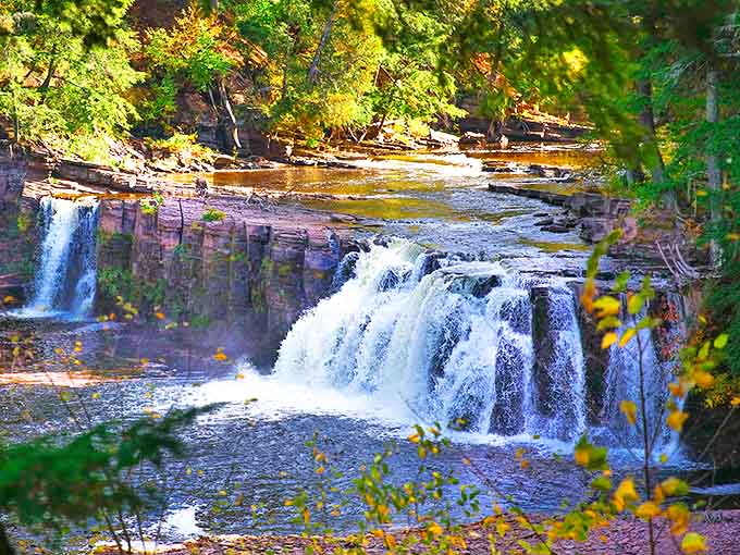 Autumn transforms this waterfall into a painter's dream, with fiery colors framing the powerful rush of water.