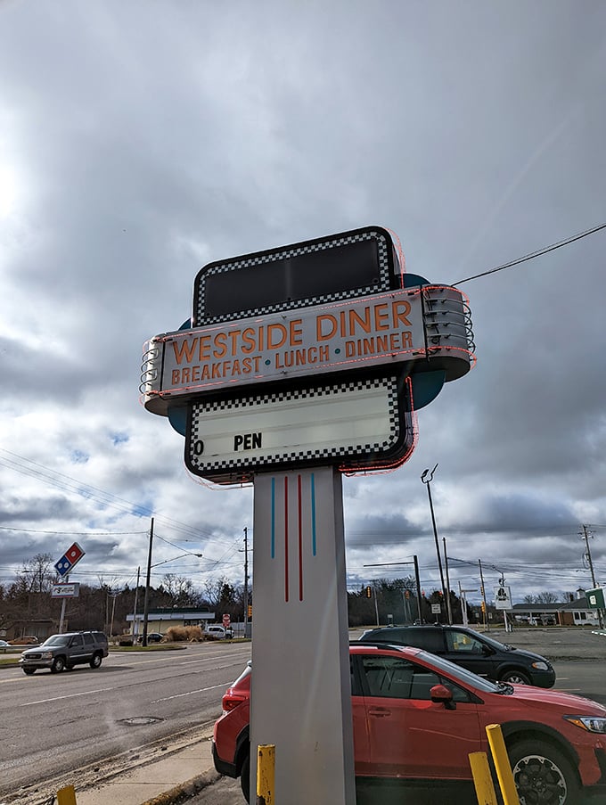 The iconic Westside Diner sign stands tall against cloudy skies, a beacon for hungry travelers seeking breakfast, lunch, or dinner classics.