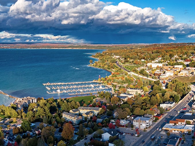 Aerial magic: Petoskey's harbor dotted with boats against the backdrop of Michigan's rolling landscape and dramatic skies.