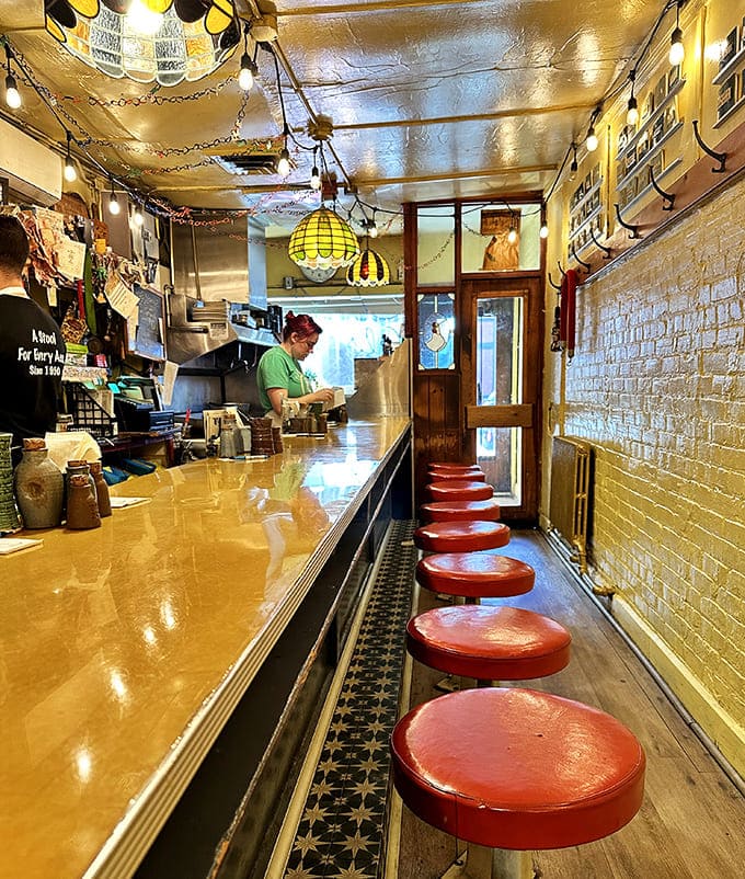 A study in beautiful efficiency: Al's narrow interior features just 14 red stools lining a counter where breakfast magic happens daily.