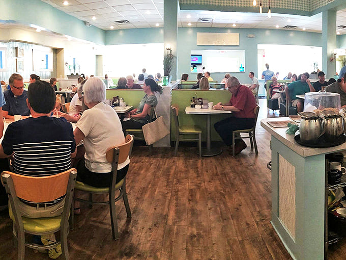 Inside, the dining room hums with morning energy as patrons settle into mint-green booths and wooden chairs.