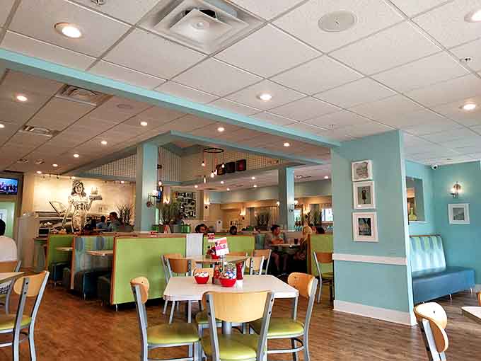 Soothing turquoise walls and colorful booth seating create the perfect backdrop for morning conversations that flow as smoothly as their coffee.