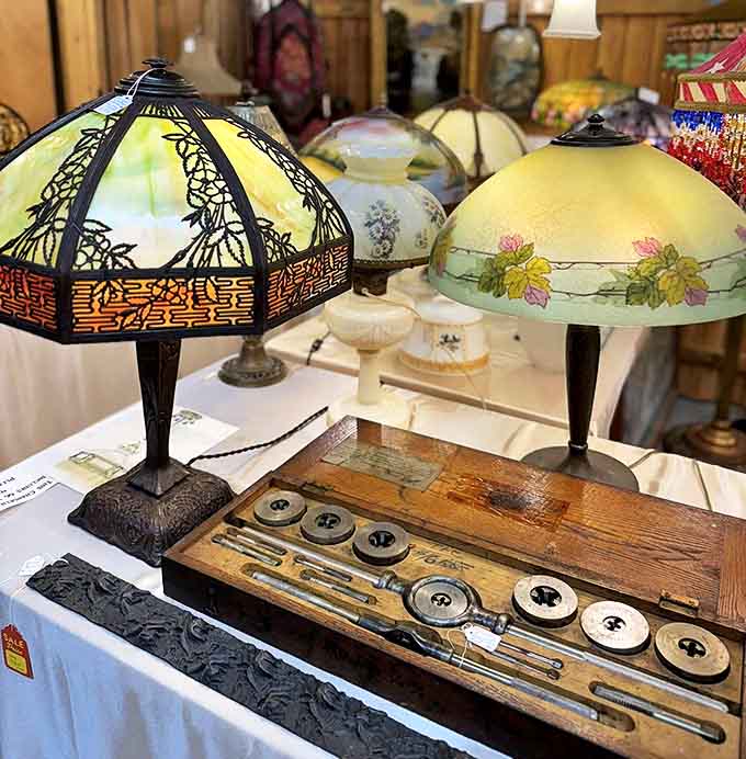 These glowing beauties once lit parlors and reading nooks, each shade telling stories through colored glass and intricate metalwork.