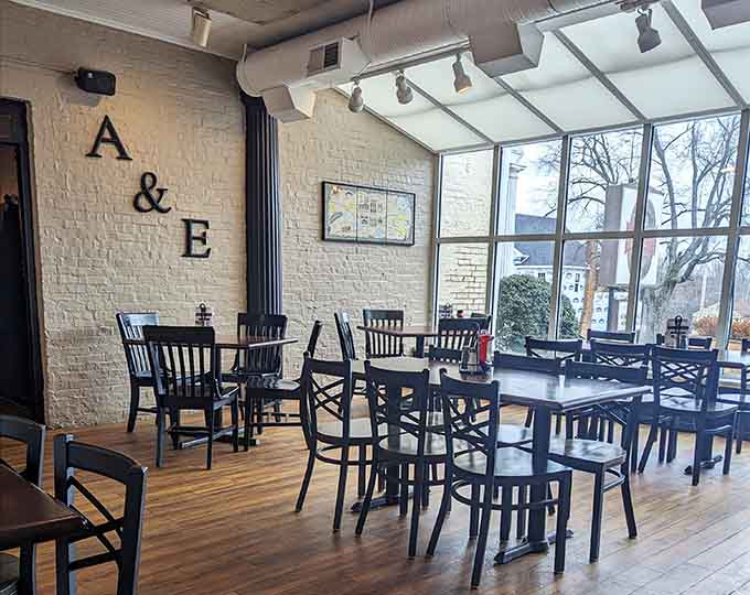 Sunlight streams through those gorgeous windows, illuminating a space where modern meets cozy in perfect harmony.