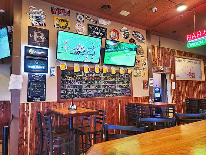 The interior buzzes with energy as sports fans gather around multiple screens, the chalkboard menu tempting patrons with dozens of craft beer options.