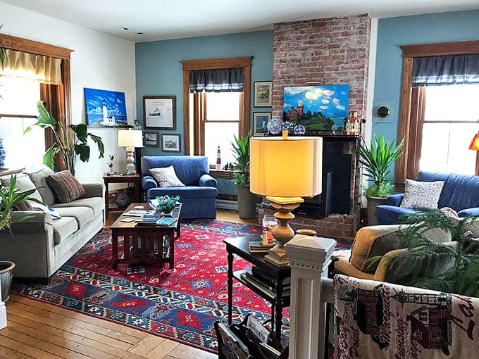 Cozy elegance defines the lighthouse's living room, where exposed brick walls meet comfortable furnishings, creating the perfect spot for afternoon reading.