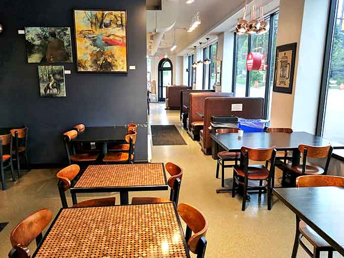 Wooden tables and dark walls create that perfect "stay awhile" vibe, where conversations flow as freely as the coffee.