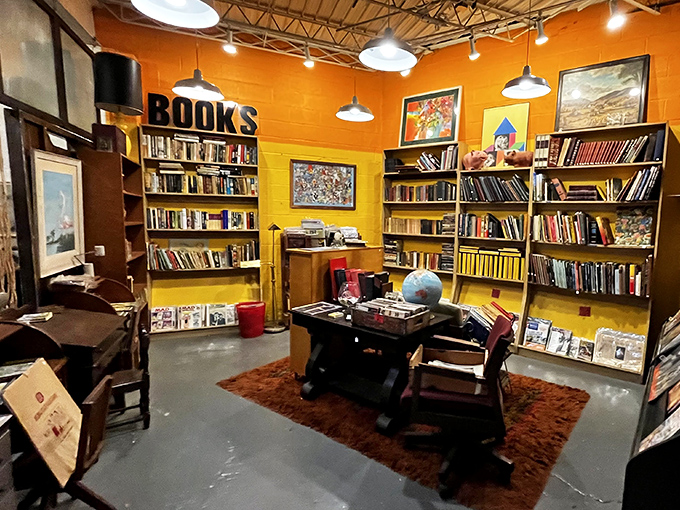 Bibliophiles rejoice! The book nook features floor-to-ceiling shelves of vintage reads in a cozy, sunshine-yellow setting perfect for literary treasure hunting.