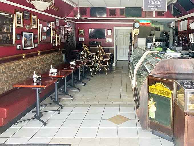 Rich burgundy walls, stone accents, and bistro-style seating transport you to a cozy Parisian caf&eacute; without the transatlantic flight.