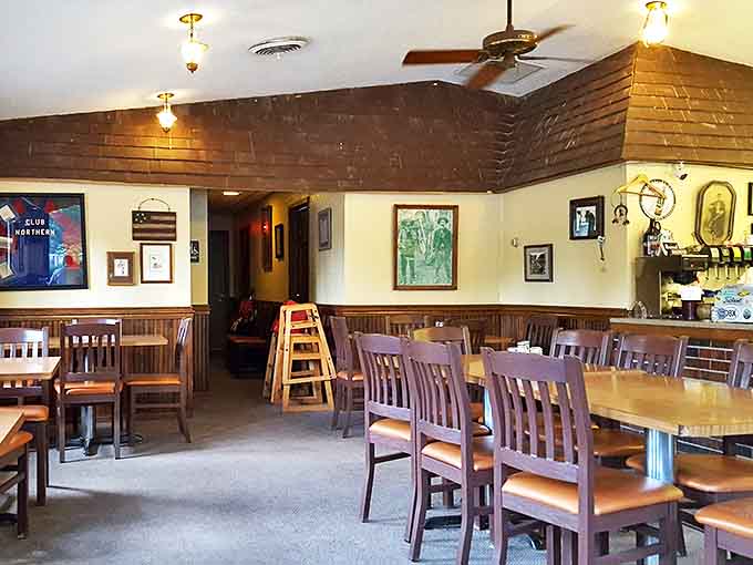 Warm wood paneling and comfortable seating create that perfect small-town atmosphere where conversations flow as freely as the pizza sauce.