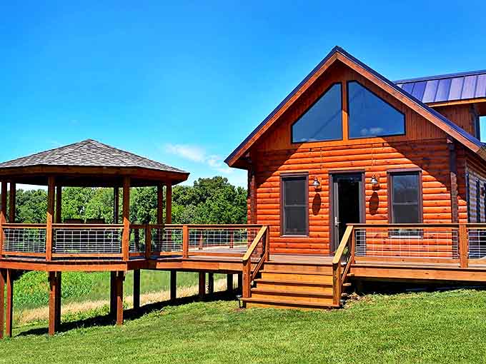 Honey-colored logs gleam in the sunshine as the cabin's warm exterior invites visitors to discover what awaits inside this hilltop haven.