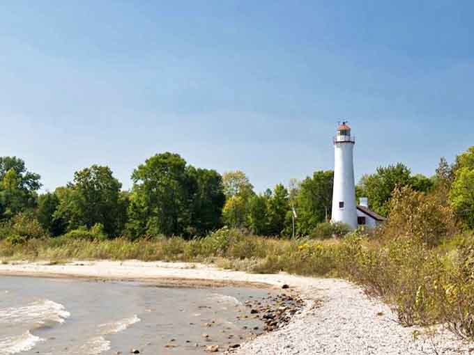 Standing tall since 1869, this coastal lighthouse has guided countless mariners to safety, its white tower a reassuring beacon against Michigan's notorious storms.