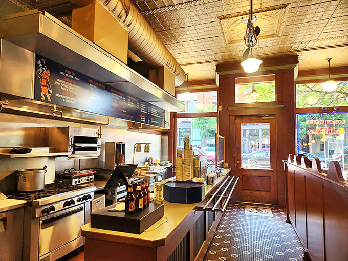 Behind this vintage counter, culinary magic happens in plain view &ndash; where hot dogs sizzle and gyros are assembled with practiced precision that comes from decades of perfection.
