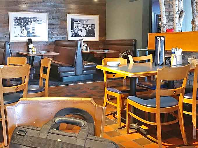 Vintage vinyl booths in purple and teal create a time capsule dining experience where conversations flow as freely as the root beer.