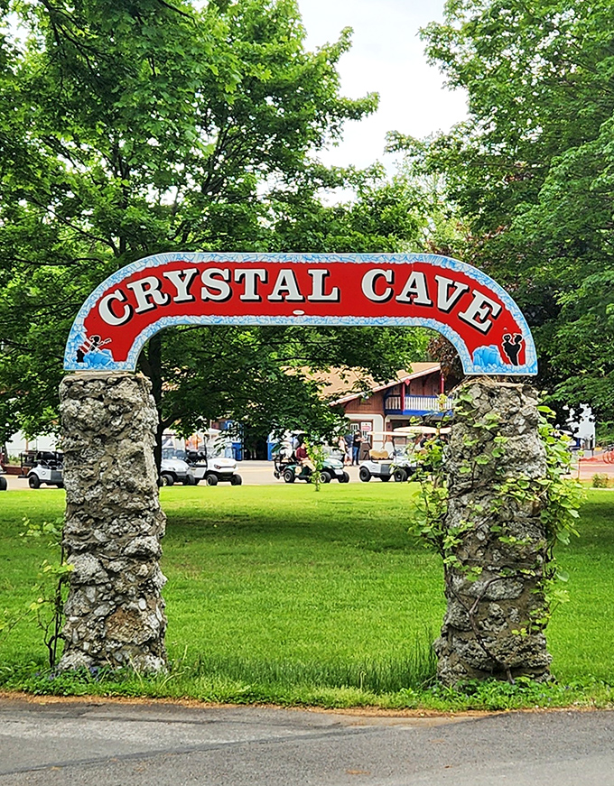 The iconic red archway welcomes visitors to Crystal Cave, offering no hint of the subterranean wonders waiting just beyond those stone pillars.