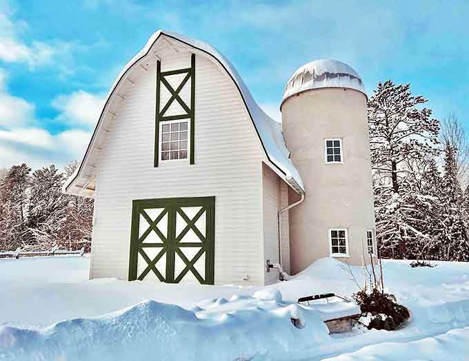 Winter transforms the Green Gate Barn Home into a snow-covered wonderland, where the warmth inside feels even more inviting against the frosty landscape.