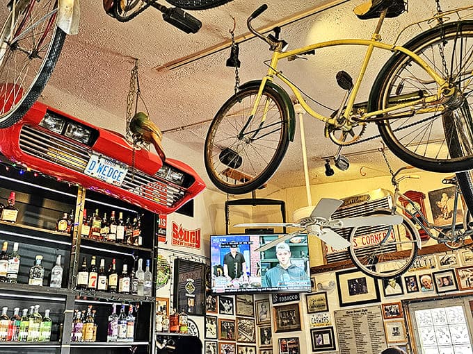 Vintage bicycles hang from the ceiling like mechanical art installations, while automotive memorabilia creates a museum-like atmosphere for diners.