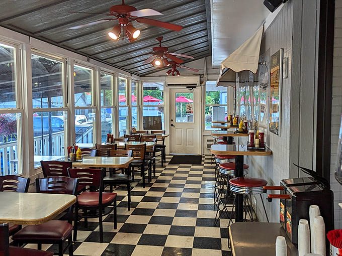 Classic checkered floors and red ceiling fans create the perfect retro atmosphere where every meal feels like a step back in time.