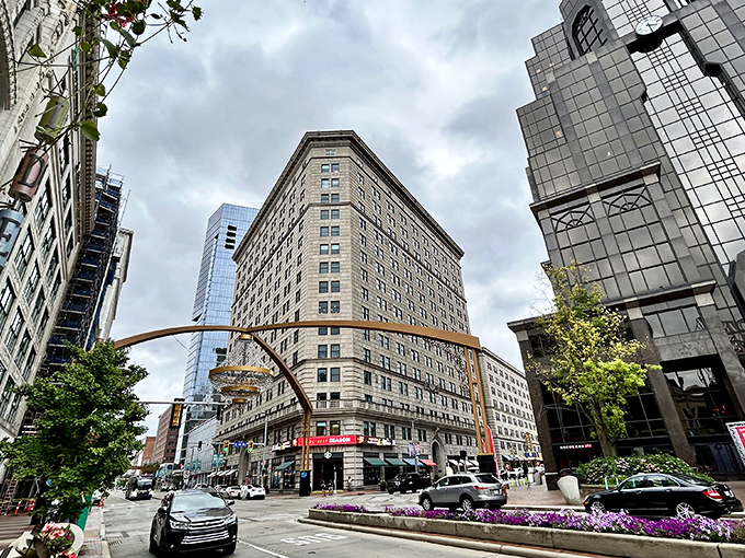 The historic Hanna Building stands sentinel beside the chandelier, its classic architecture providing the perfect backdrop for this modern crystal marvel.